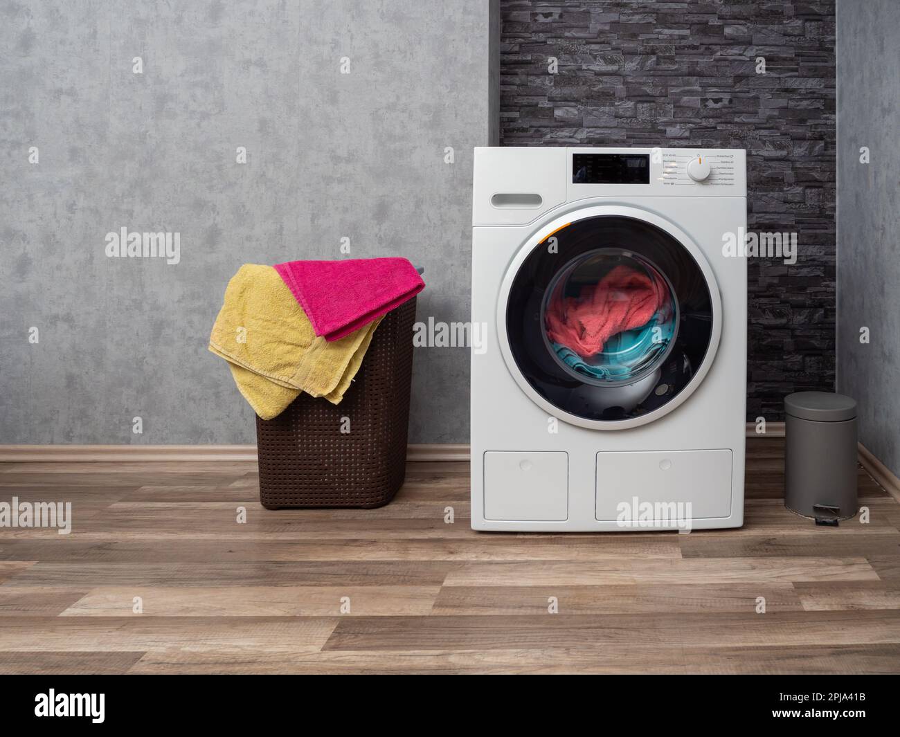 Laundry room interior with washing machine against the wall. Modern ...
