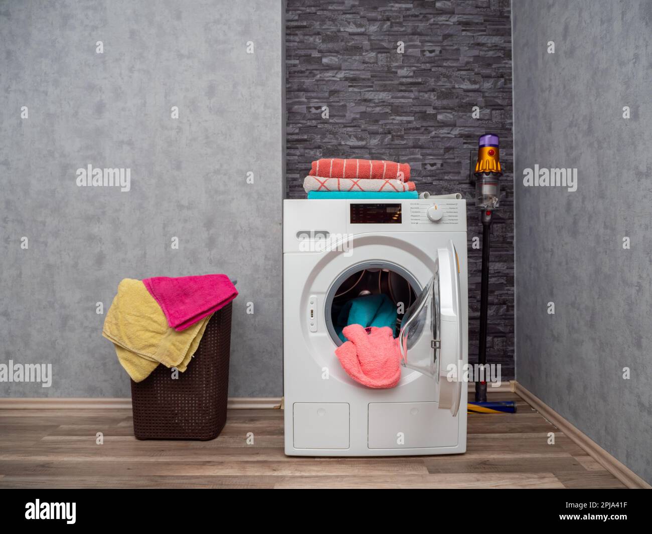 Laundry room interior with washing machine against the wall. Modern ...