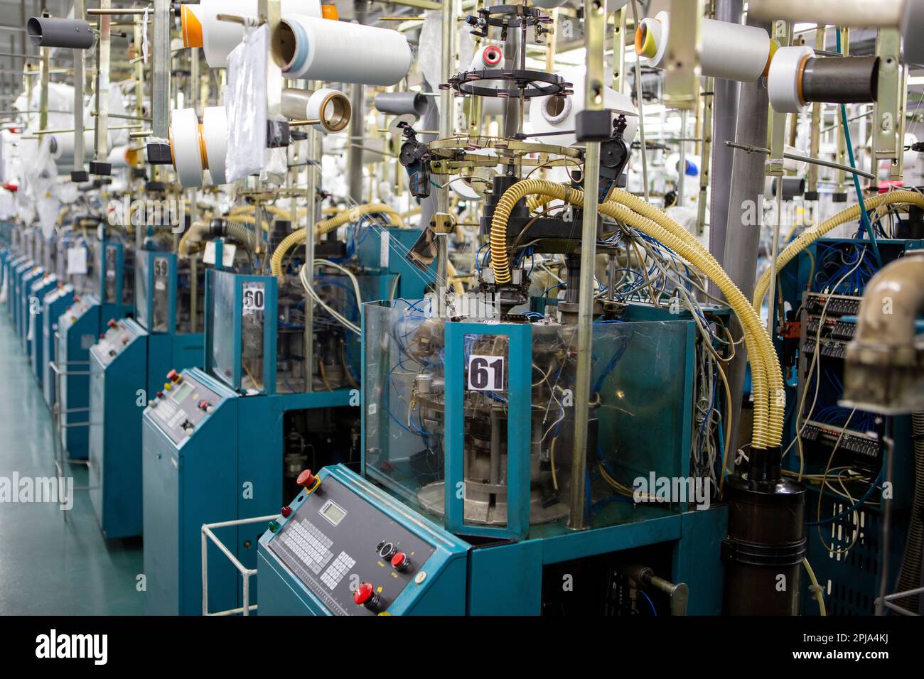 Textile industry with knitting machines in factory. Textile industry ...