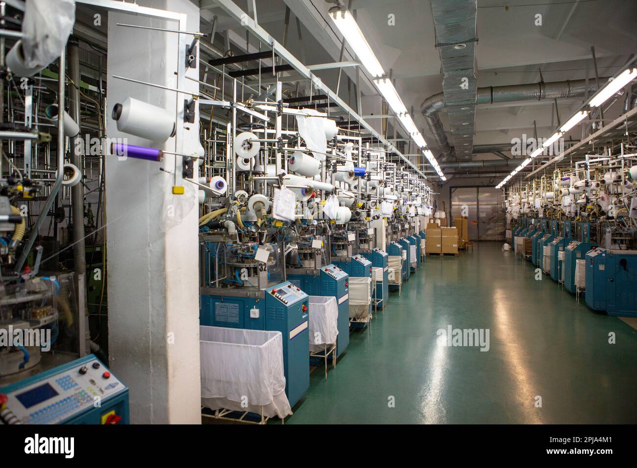 Textile industry with knitting machines in factory. Textile industry ...