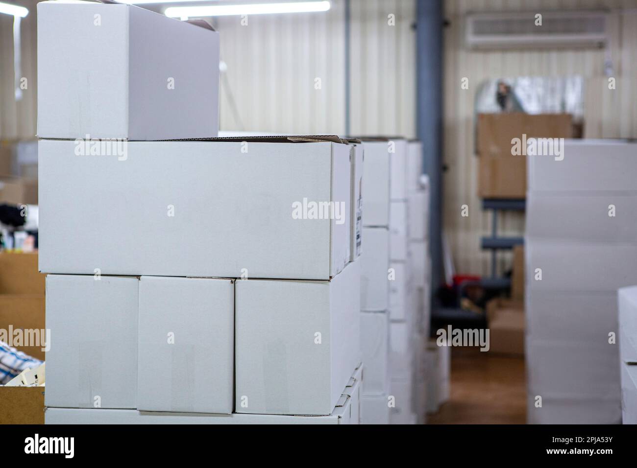 warehouse with white boxes Stock Photo - Alamy