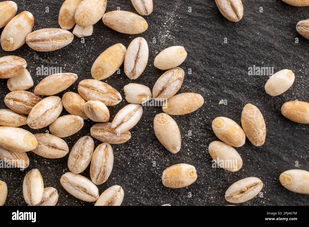 Organic pearl barley on slate stone, close-up, top view Stock Photo - Alamy