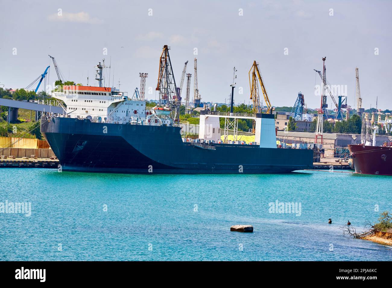 Vessel dry cargo on loading, unloading in port. Bulker in port Stock Photo - Alamy