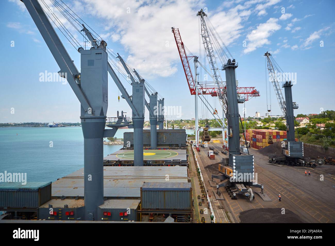 Operations with coal in seaport. Loading coal on bulk carrier. Coal ...