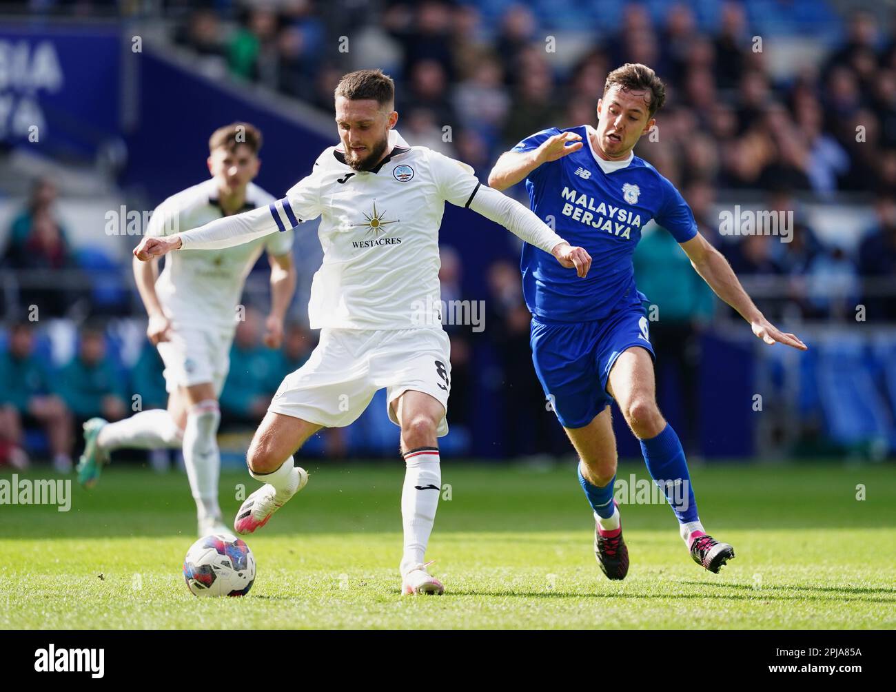 Swansea City's Matt Grimes (left) and Cardiff City's Ryan Wintle battle ...