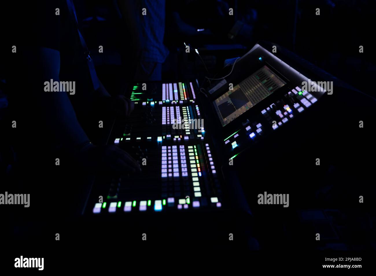 sound engineer's console during the concert with illuminated buttons ...