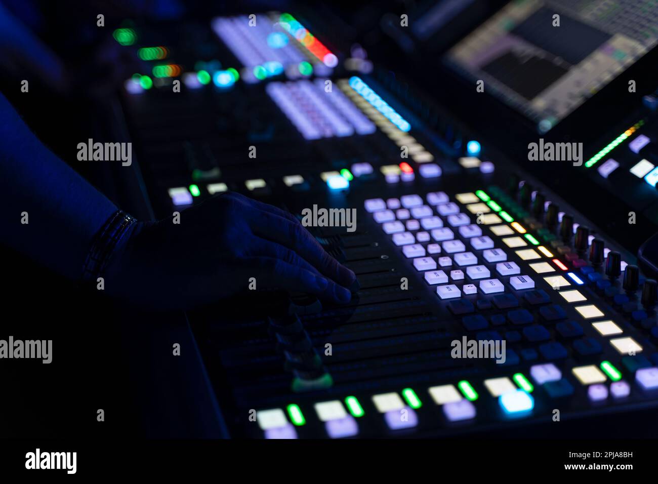 sound engineer's console during the concert with illuminated buttons ...