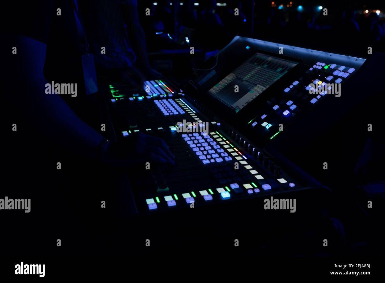 sound engineer's console during the concert with illuminated buttons ...