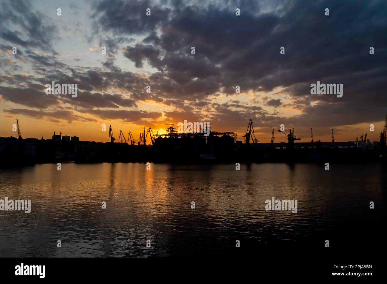 sunset in industrial landscape of commercial seaport. Sunset at seaport ...