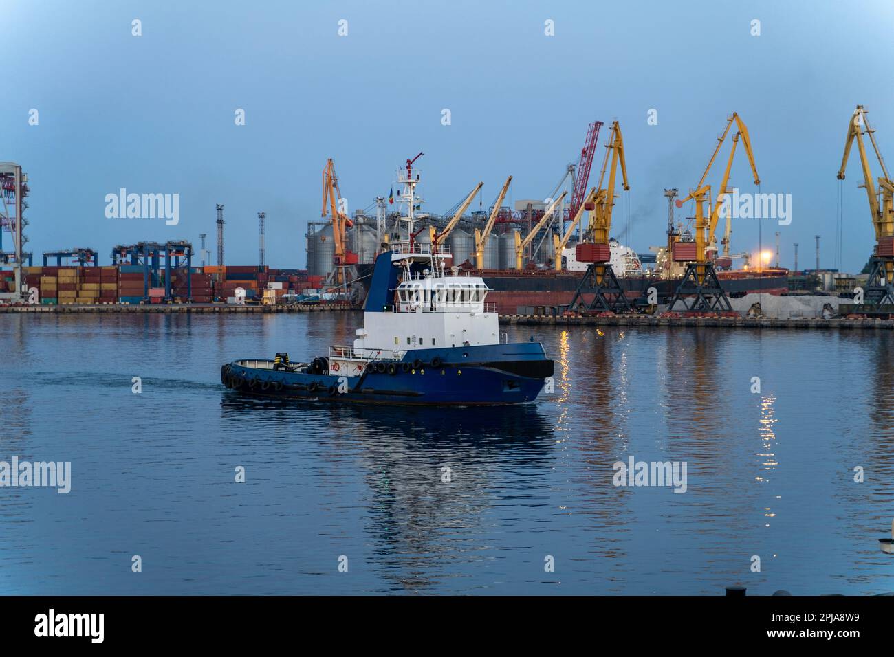 Large tugboat moves in port area Stock Photo - Alamy