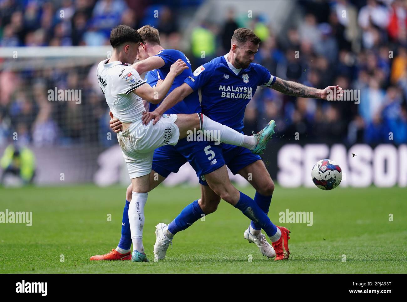 Swansea City's Luke Cundle (left) battles with Cardiff City's Mark ...