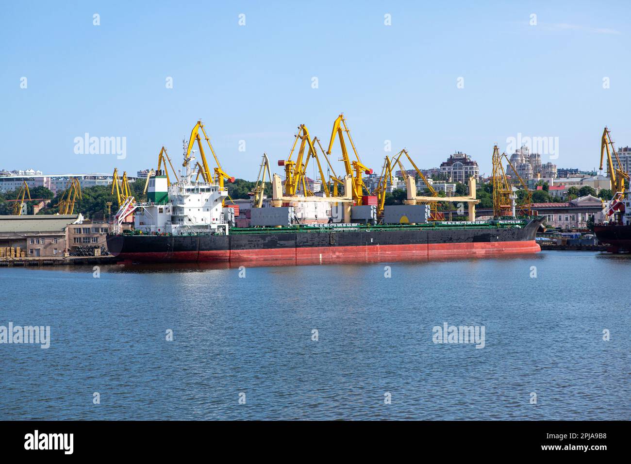 Port terminal of bulk cargo. Bulker vessel at the port terminal Stock ...