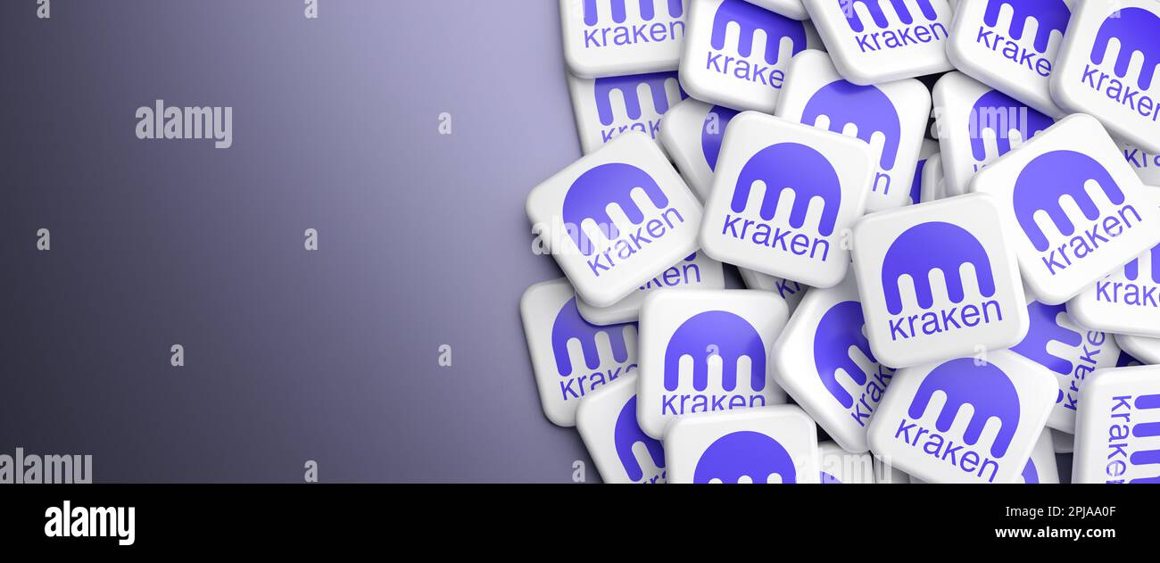 Logos of the cryptocurrency exchange Kraken on a heap on a table. Web ...
