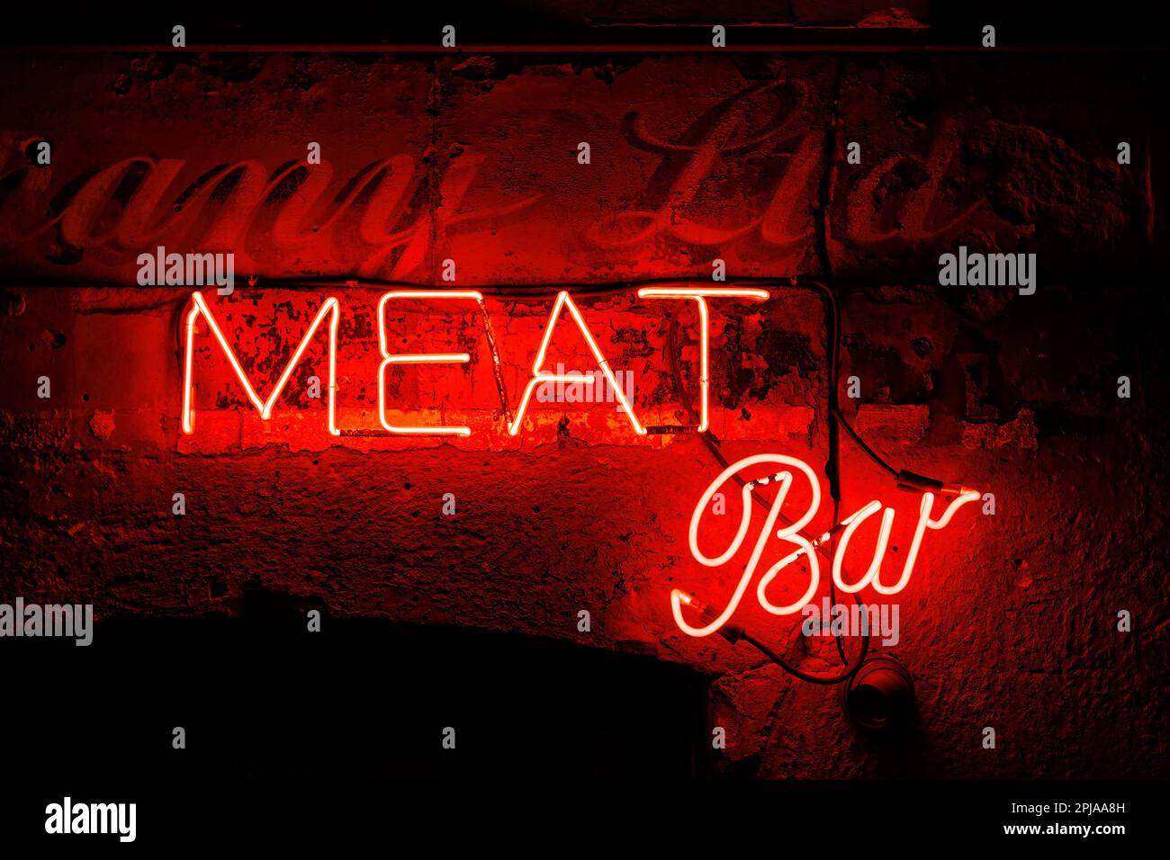 neon signage overlying older painted signs Stock Photo - Alamy