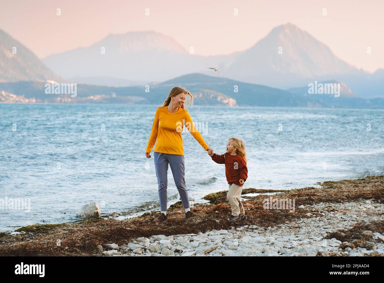 Mother and child walking outdoor family lifestyle travel together ...