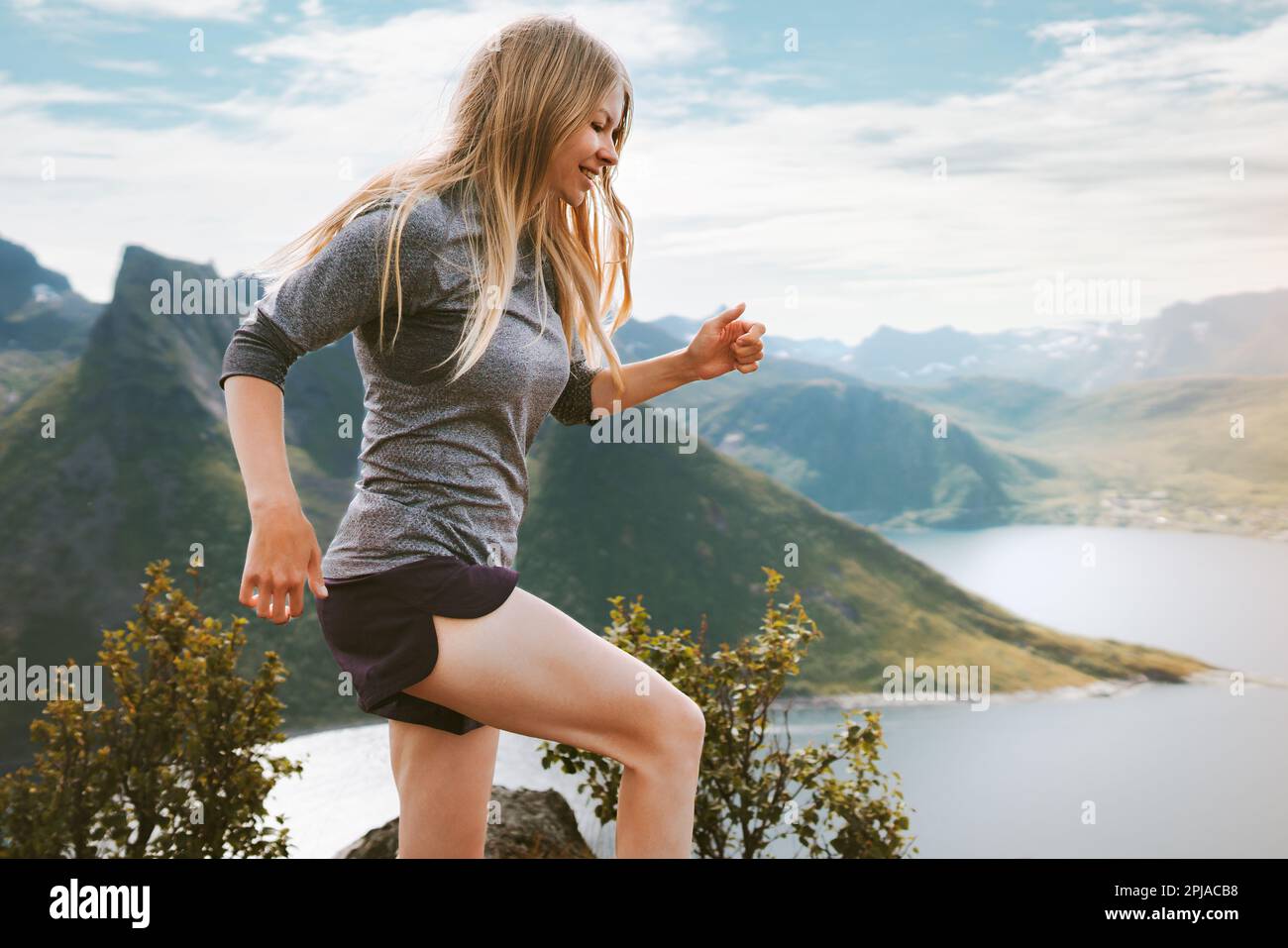 Active woman trail running in Norway mountains outdoor travel healthy ...