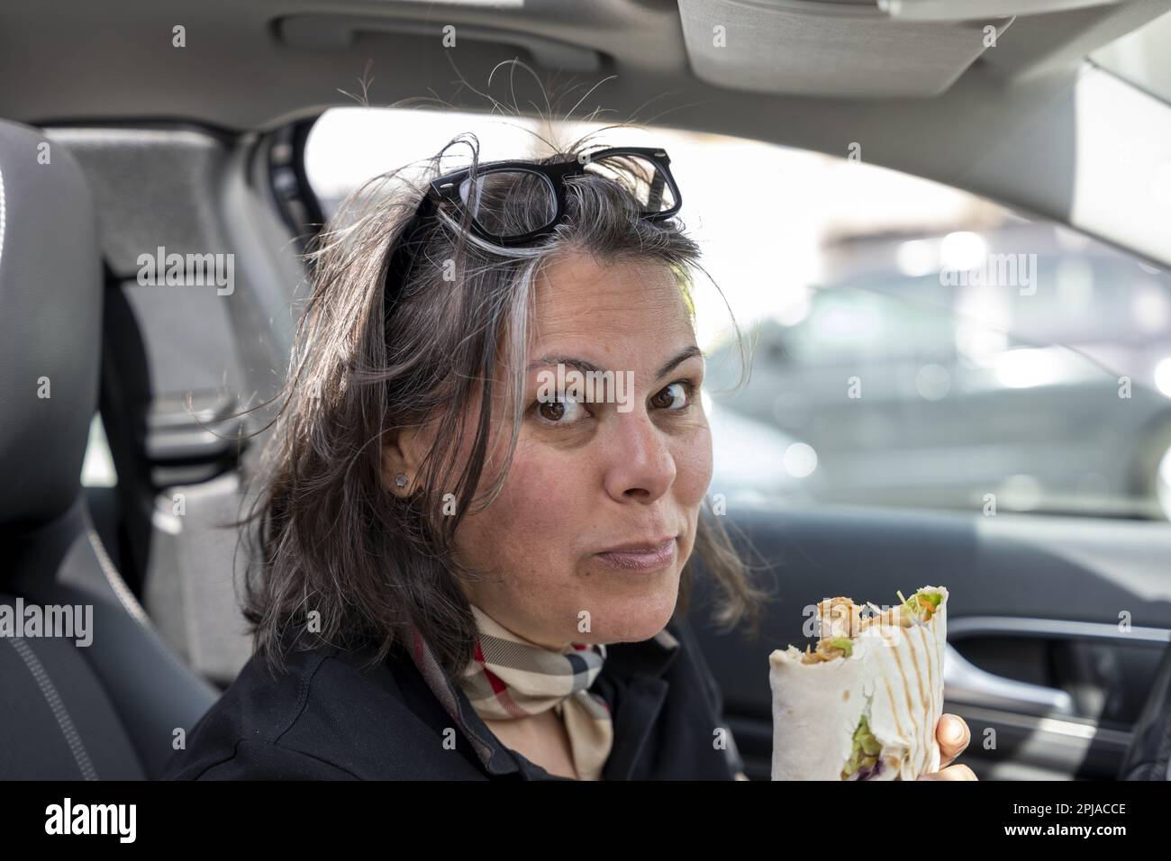 Elegant Woman Eating a Kebab in a Car in Switzerland Stock Photo - Alamy