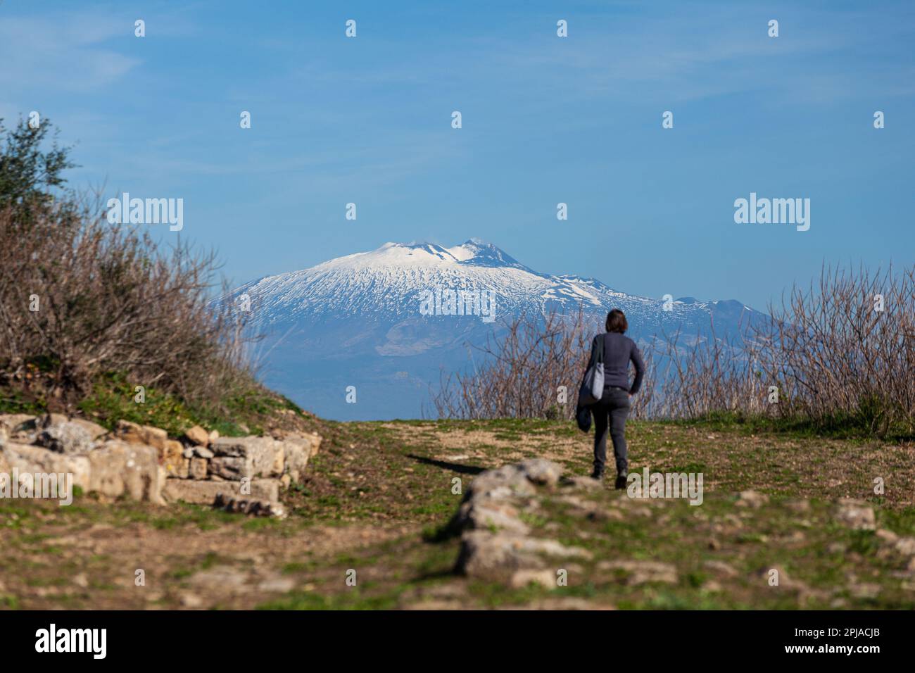 A tourist watch the Etna volcano from Morgantina, Sicily Stock Photo ...