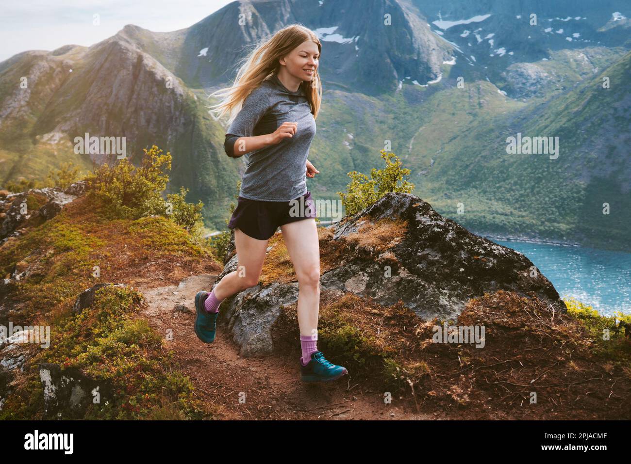 Woman athlete trail running outdoor in mountains active travel healthy ...