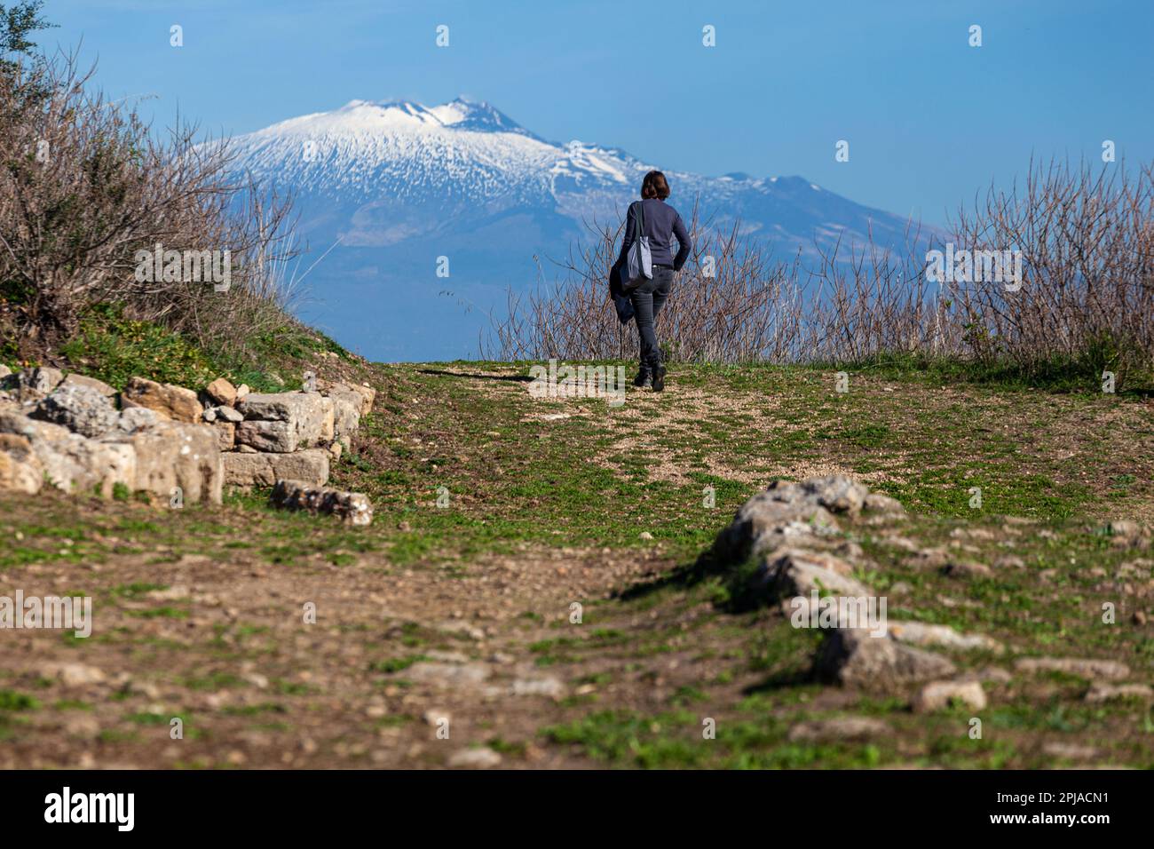 A tourist watch the Etna volcano from Morgantina, Enna. Sicily Stock ...