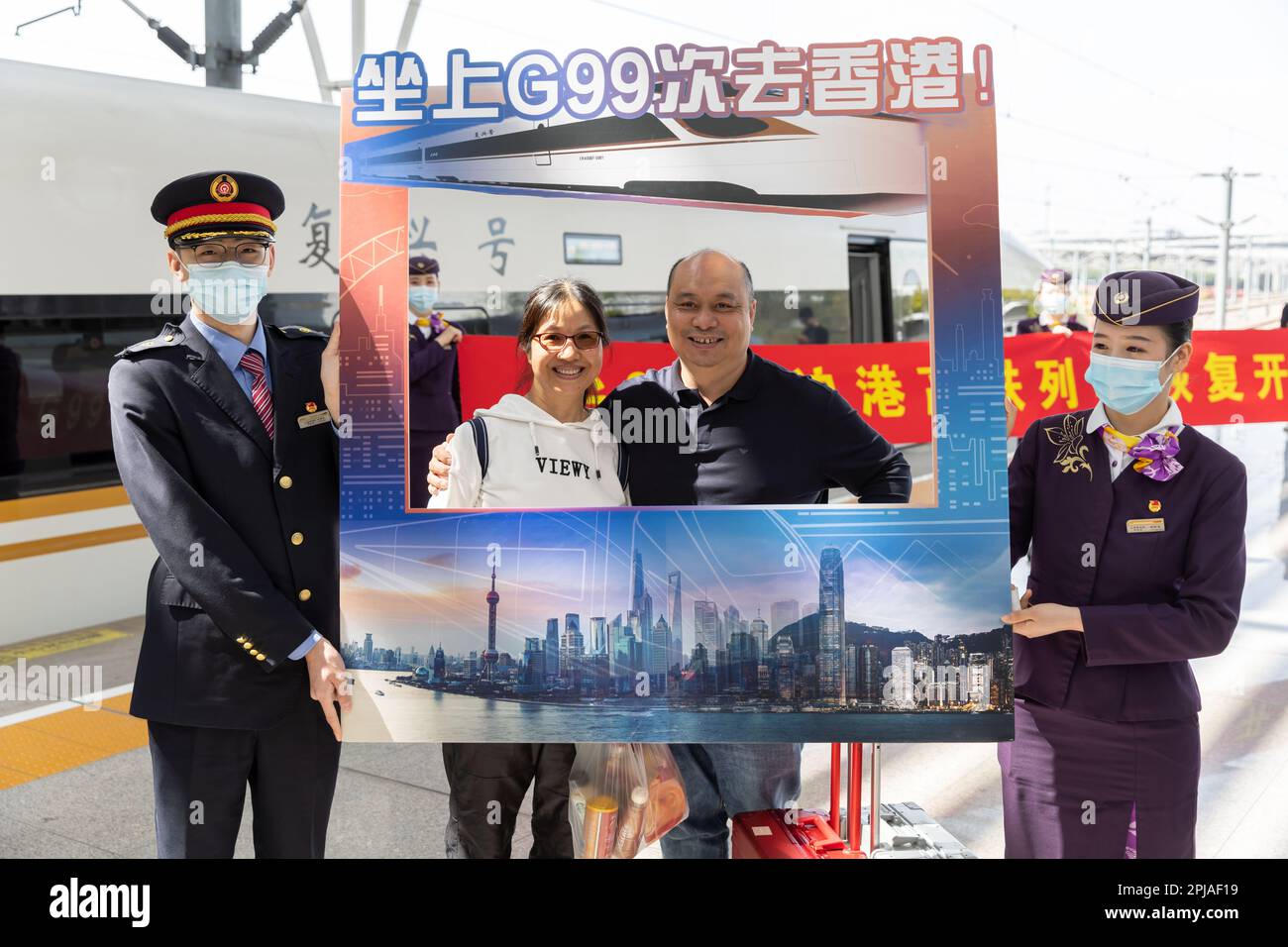 Shanghai. 1st Apr, 2023. Passengers pose for photos before boarding the ...