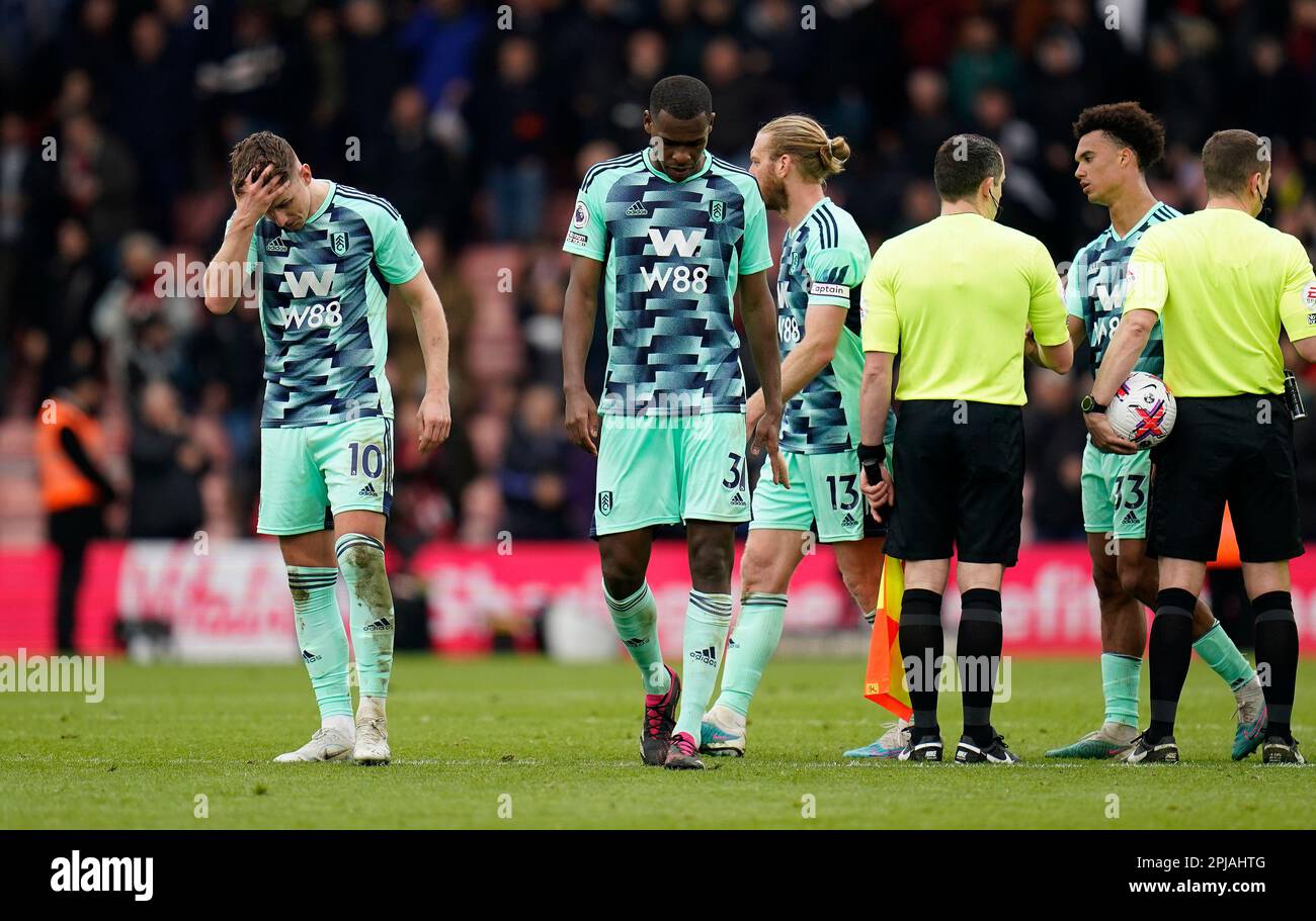 Fulham's Tom Cairney (left) and Issa Diop (centre) appear dejected ...