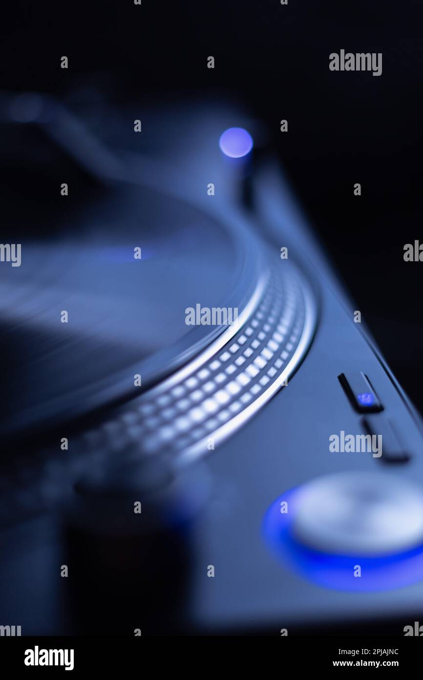 Turntable playing vinyl record with music in close up, focus on ...