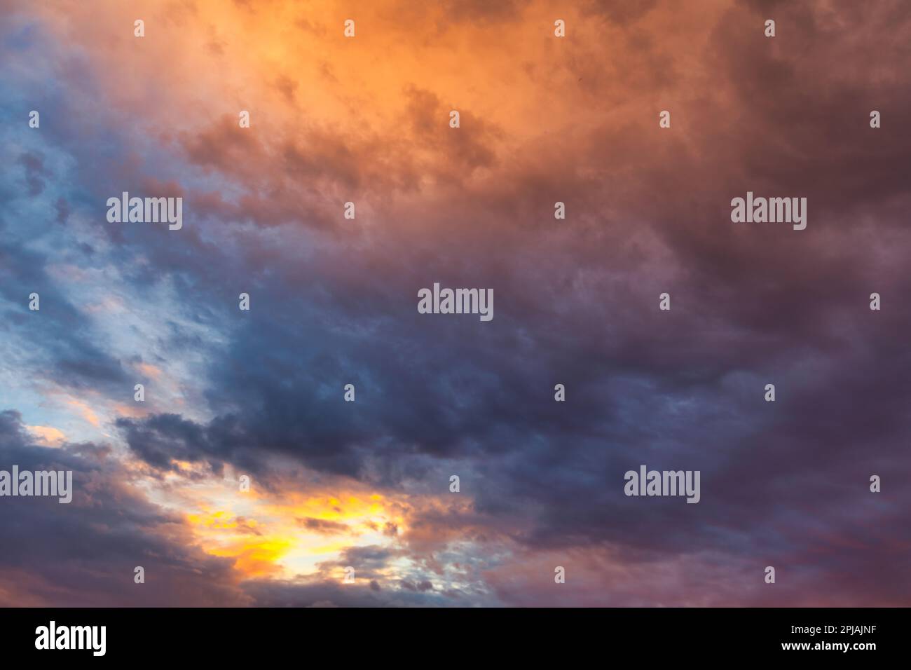 Experience the breathtaking beauty of storm clouds under a setting sun ...