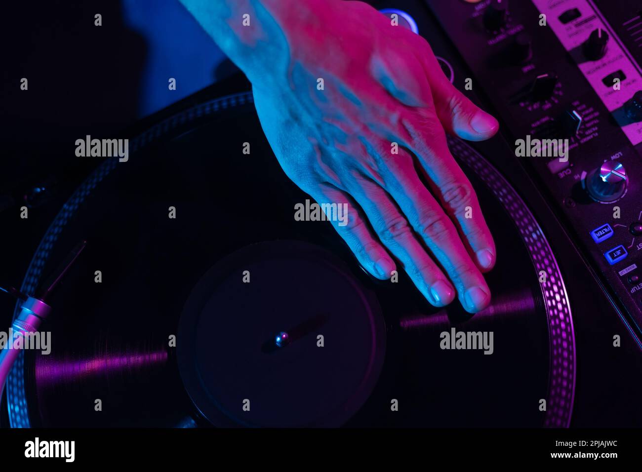 Hip hop DJ scratching vinyl record on turntable. Club disc jockey ...