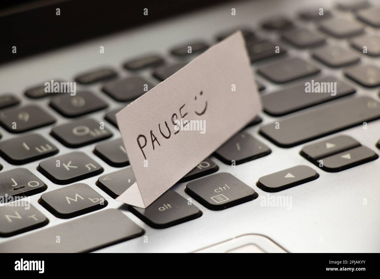 Pause and smiley handwritten on a piece of paper and left Stock Photo ...