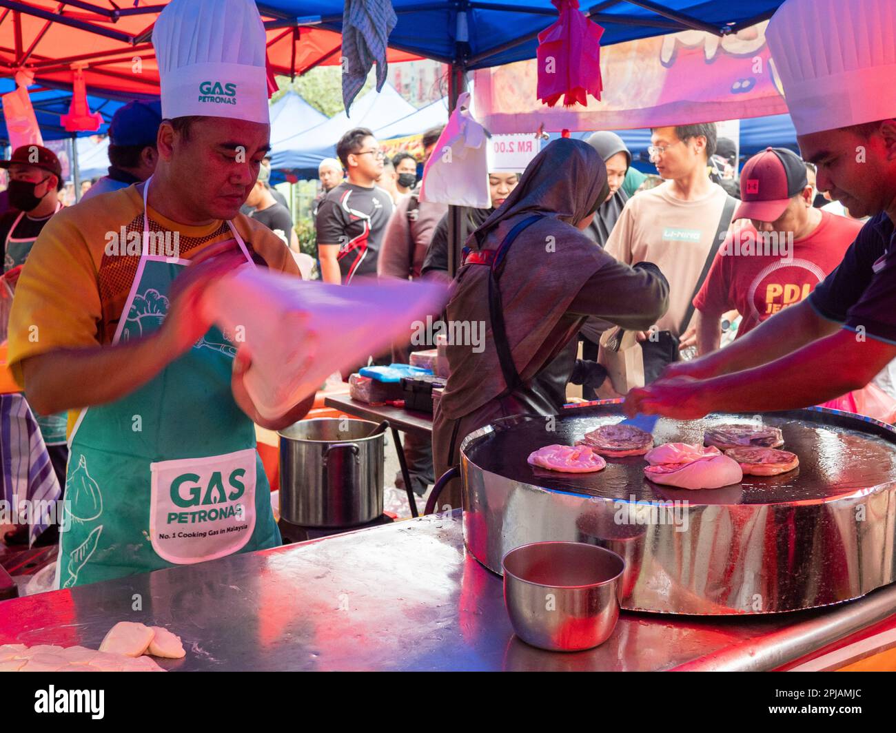 A Ramadan bazaar seller flipping roti canai at the Kampung Baru Ramadan ...