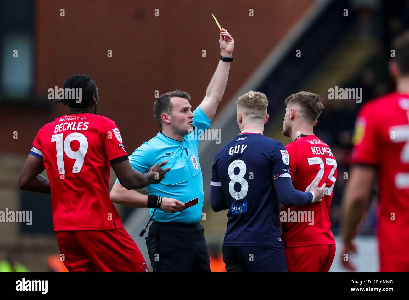 Referee Ben Speedie shows Leyton Orient's Charlie Kelman (right) a ...