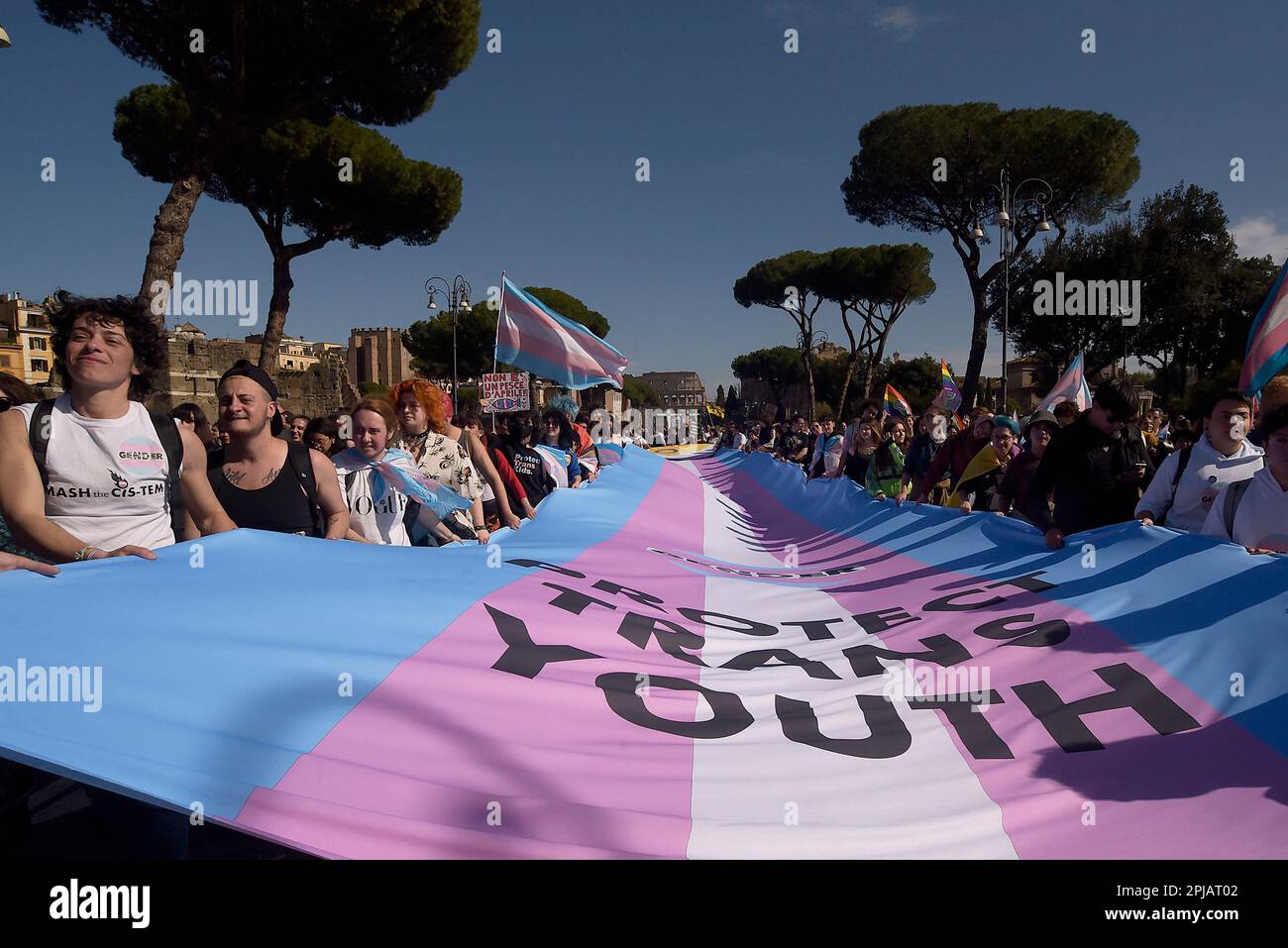 A giant transgender flag is carried by protesters during Transgender ...