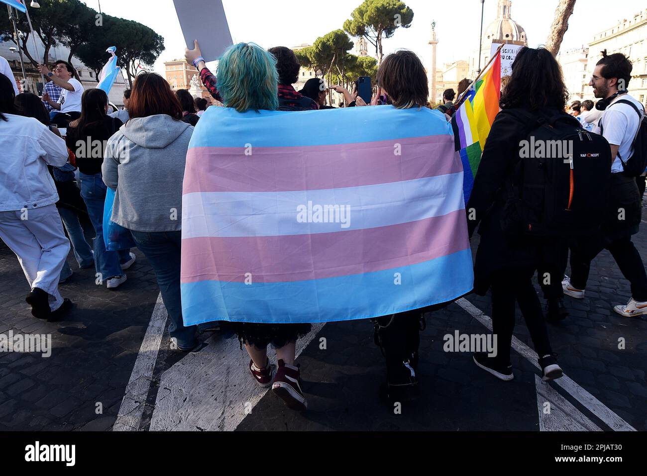 Two people wrapped in the transgender flag are seen during the ...