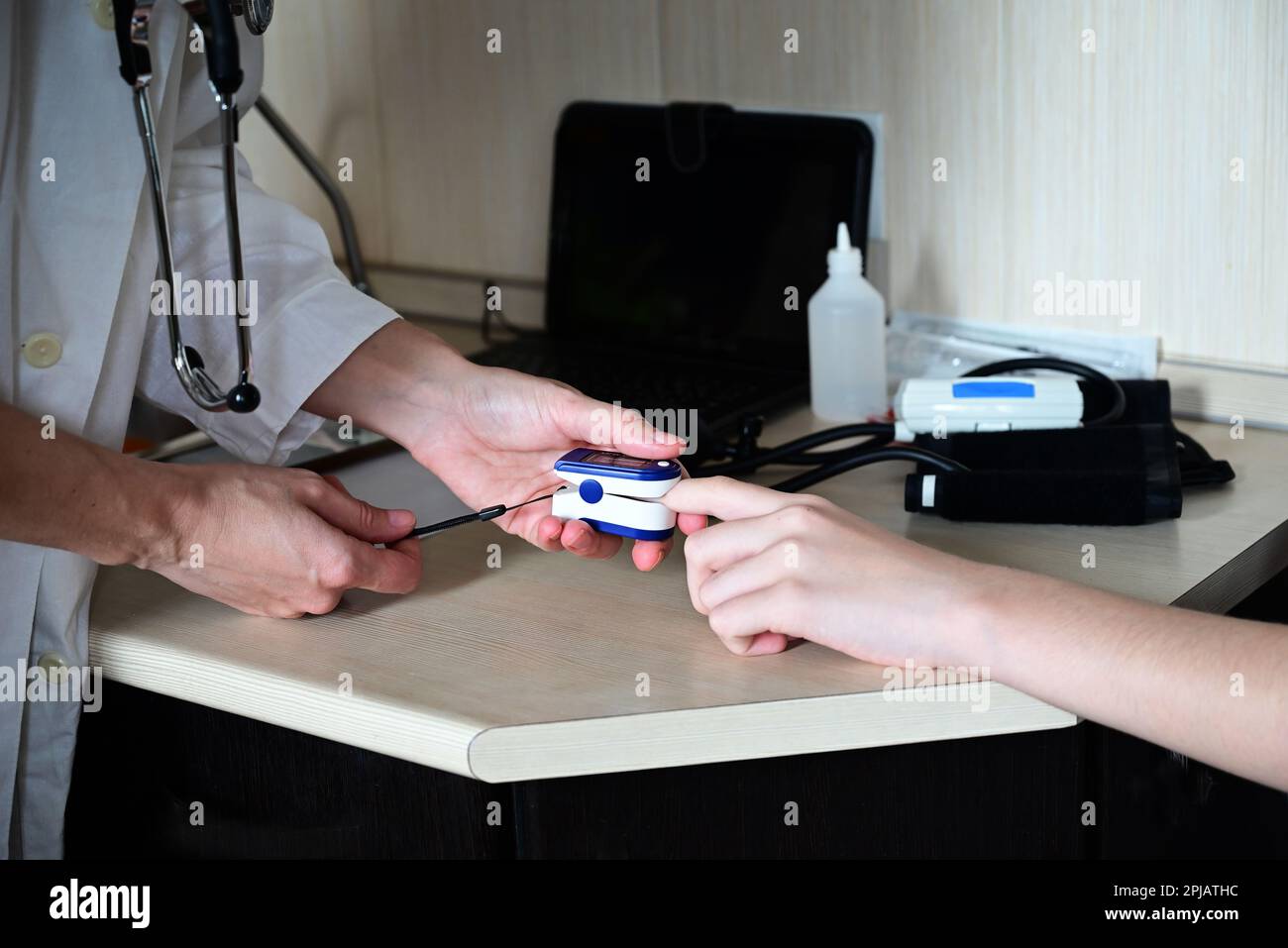Oxygen test for the covid. Doctor examining patient with fingertip ...
