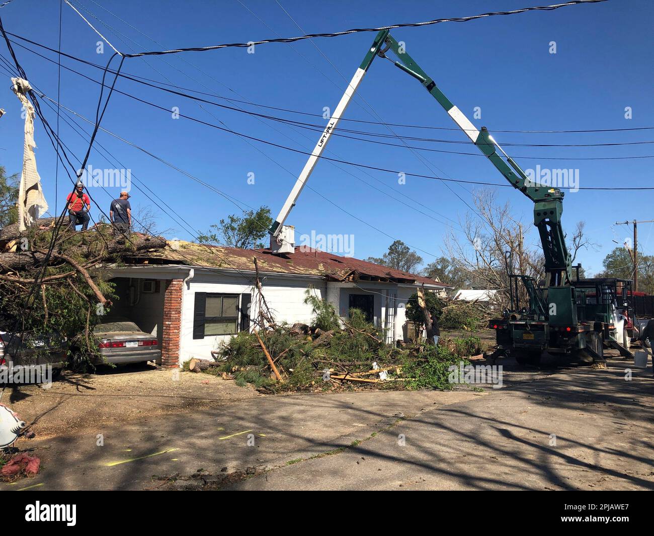 Debris is removed from a home in Wynne, Ark., on Saturday, April 1 ...