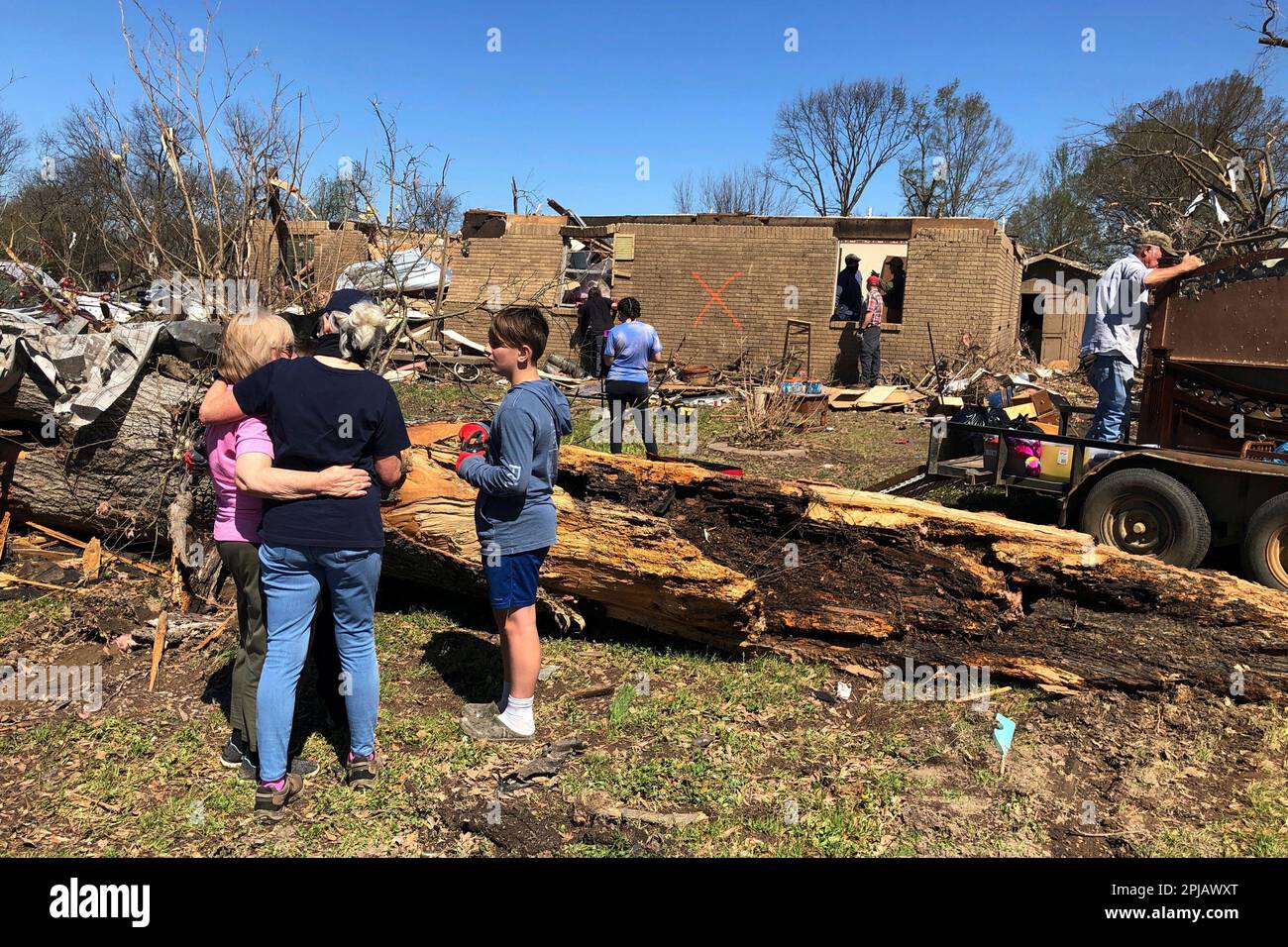 Debris covers the ground around damaged homes in Wynne, Ark., on ...