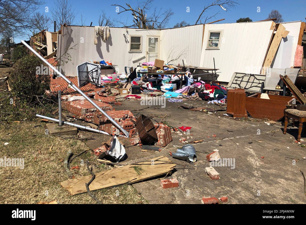Debris covers the ground around damaged homes in Wynne, Ark., on ...