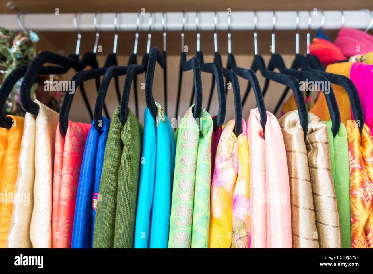 Colorful vibrant Indian Sarees in wardrobe Stock Photo - Alamy