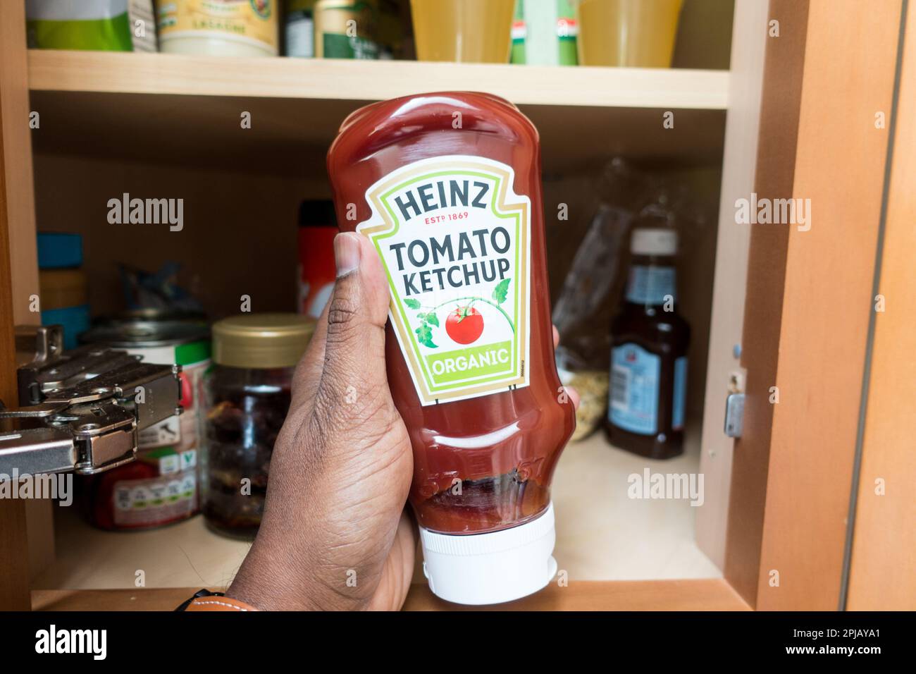 Adult male holding Ketchup by Heinz Stock Photo - Alamy
