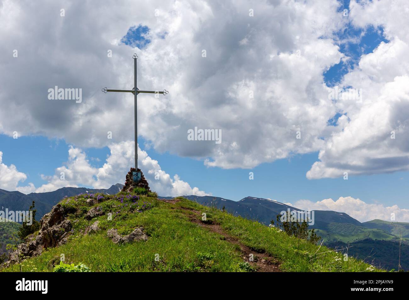 Roadside religious cross with orthodox Saint icon on a hill on M-20 ...