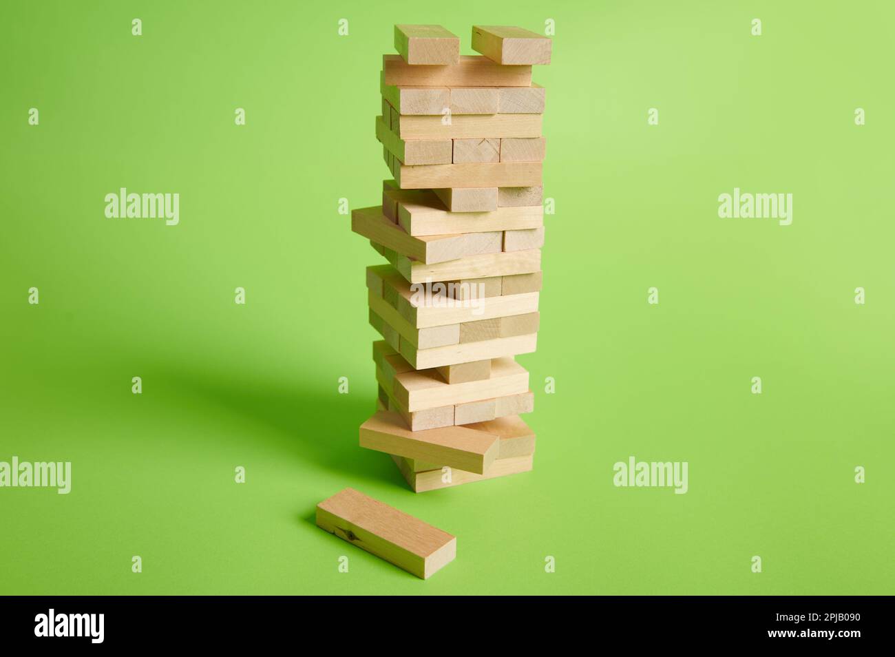 Wooden block tower on the green background. Board game game of physical ...
