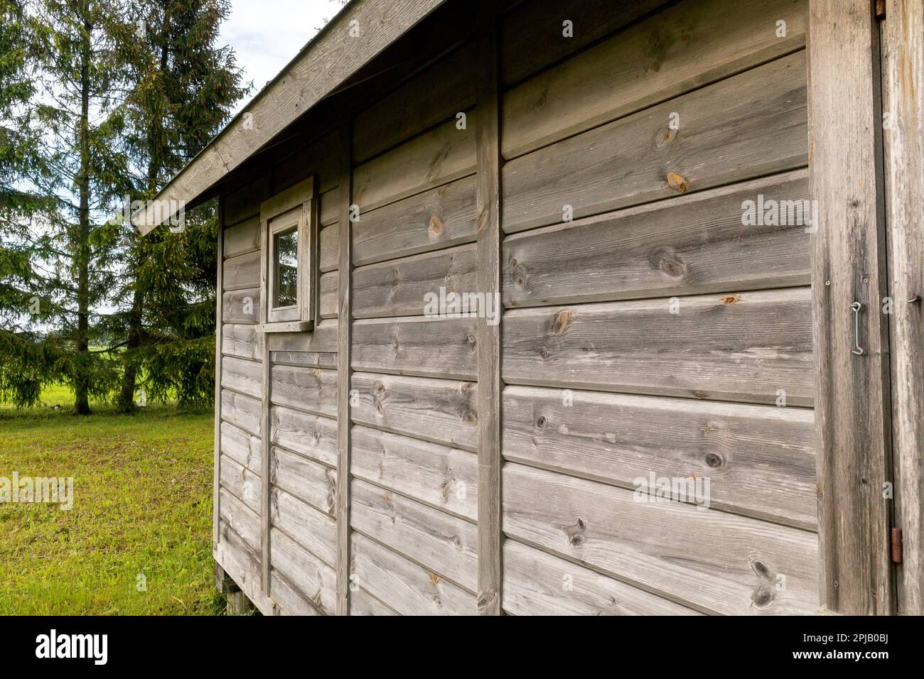 A wooden building with a window Stock Photo - Alamy
