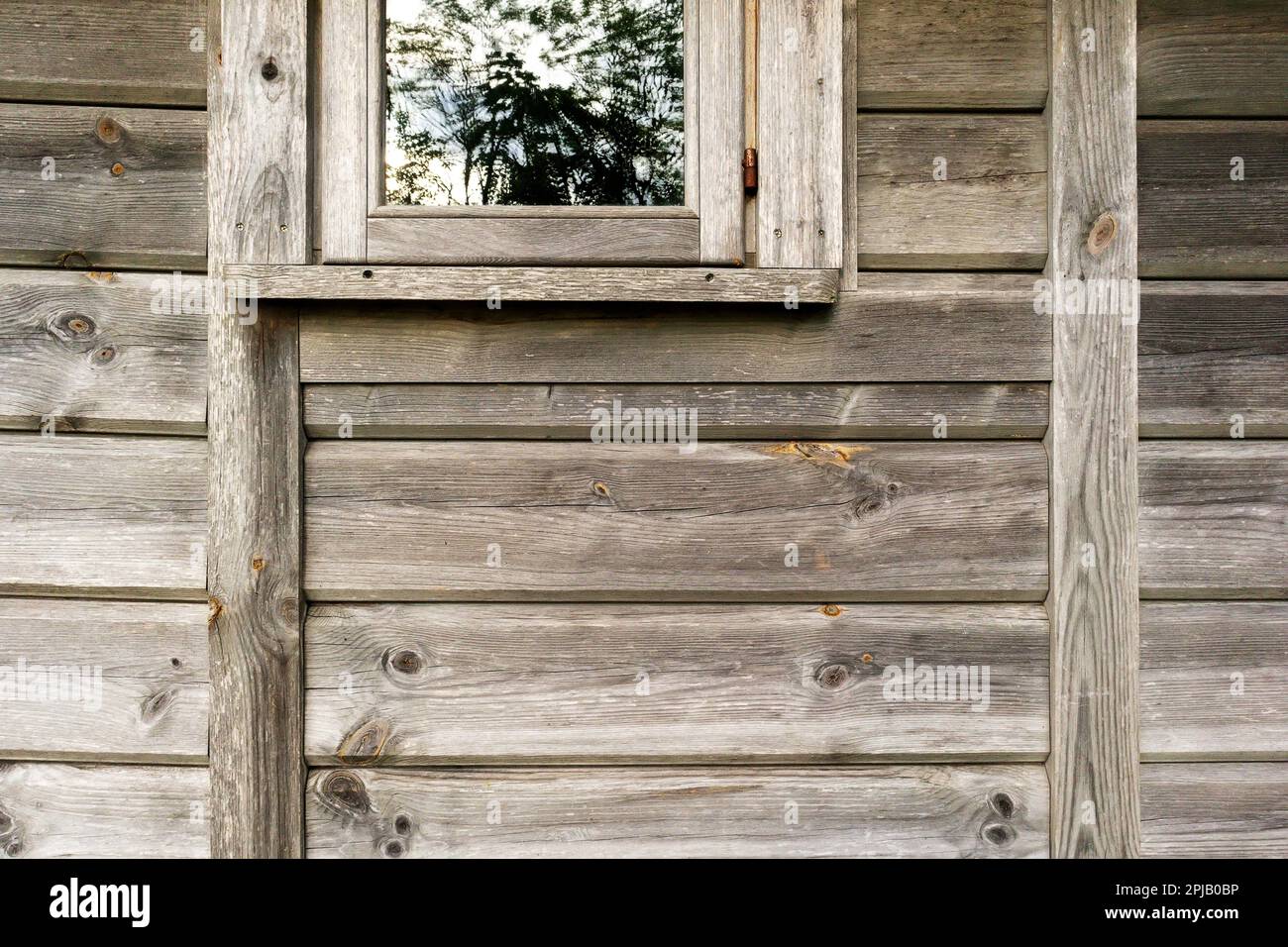 A wooden building with a window Stock Photo - Alamy