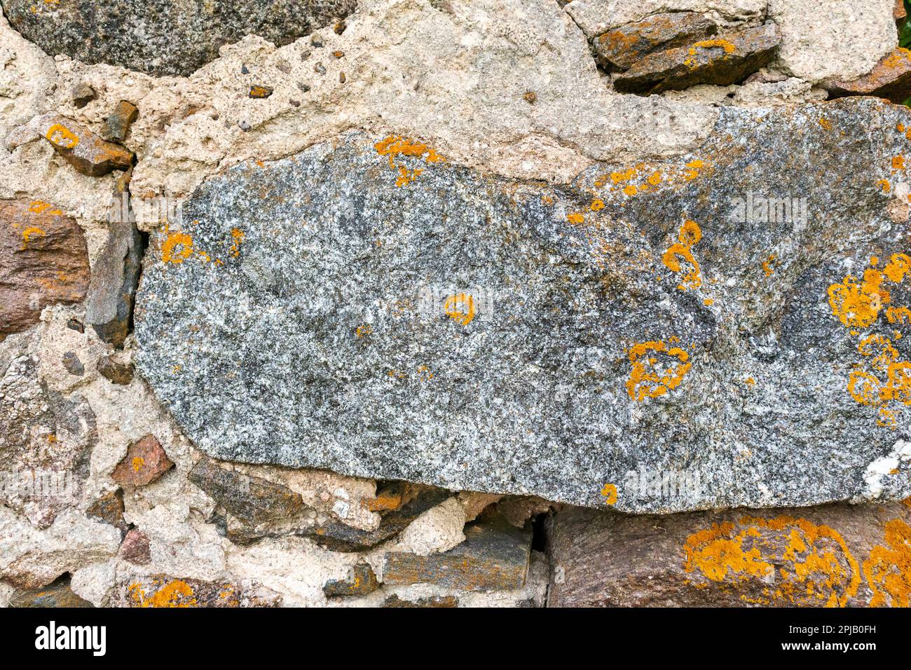 A stone wall with small stones in gray and brown Stock Photo - Alamy