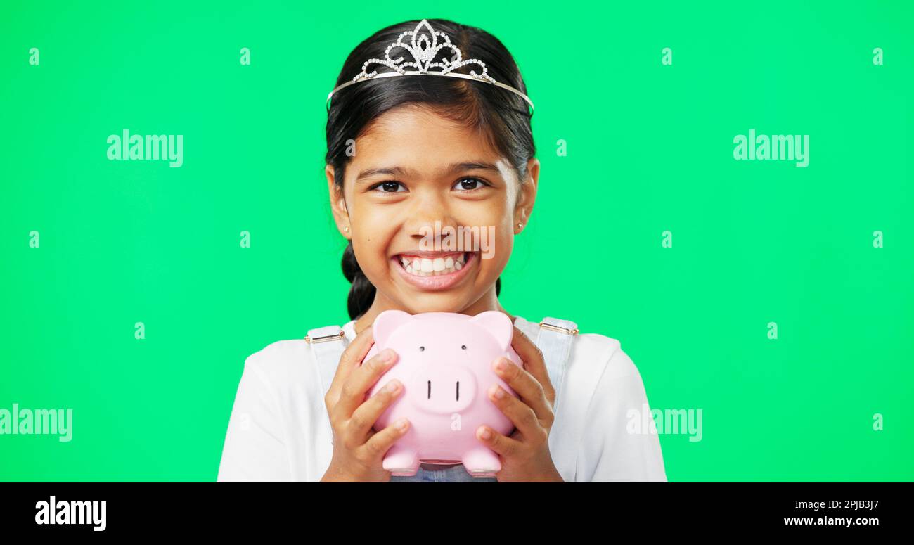 Girl, piggy bank and face with smile in studio by green screen for ...