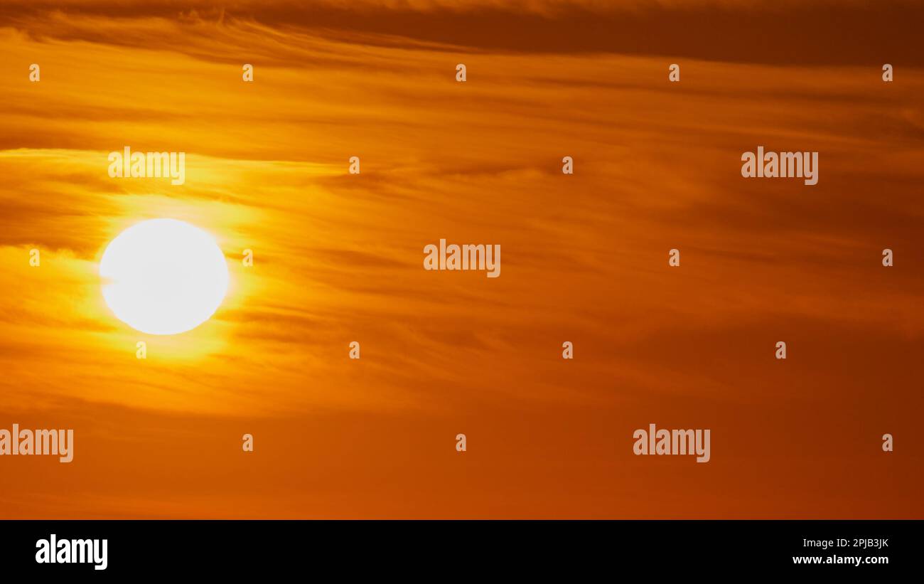 Evening red sun in the clouds at sunset sets over the horizon Stock ...