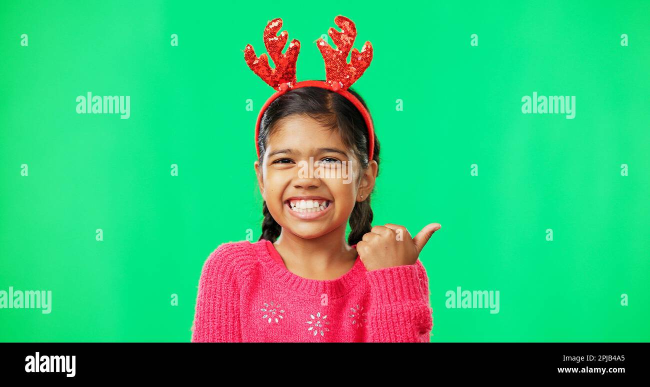Christmas, green screen and a girl in a reindeer antlers headband ...