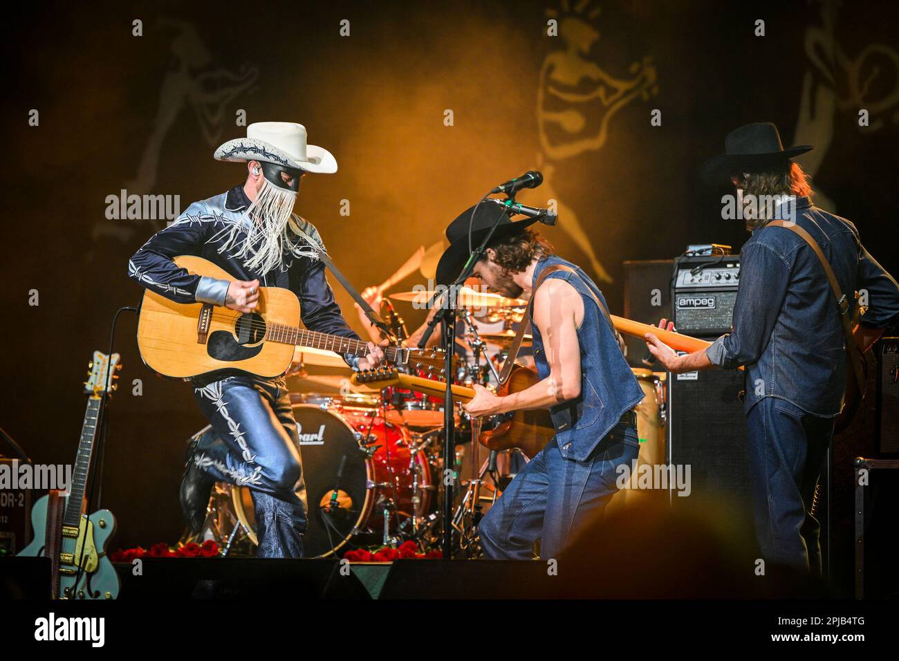 Orville Peck, wearing drag, dress up, fringe mask and barbed wire motif ...