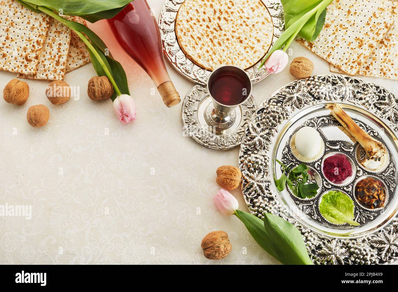 Passover Seder plate with traditional food, walnuts, matza and wine on ...